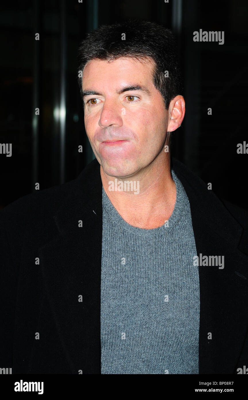 SImon Cowell pulls funny faces as arrives back at his Manchester Hotel ...