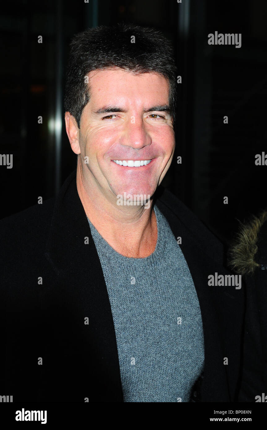SImon Cowell pulls funny faces as arrives back at his Manchester Hotel ...
