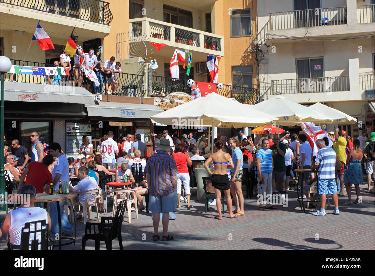 England football fans outside bars in Buġibba Square watch their team's ...