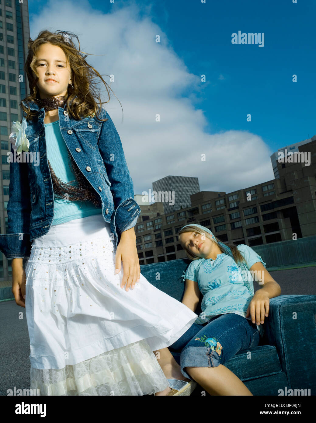 2 teenage girls on building roof Stock Photo - Alamy