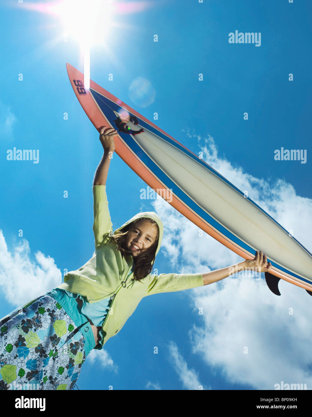 Teenage girl holding windsurf board Stock Photo - Alamy