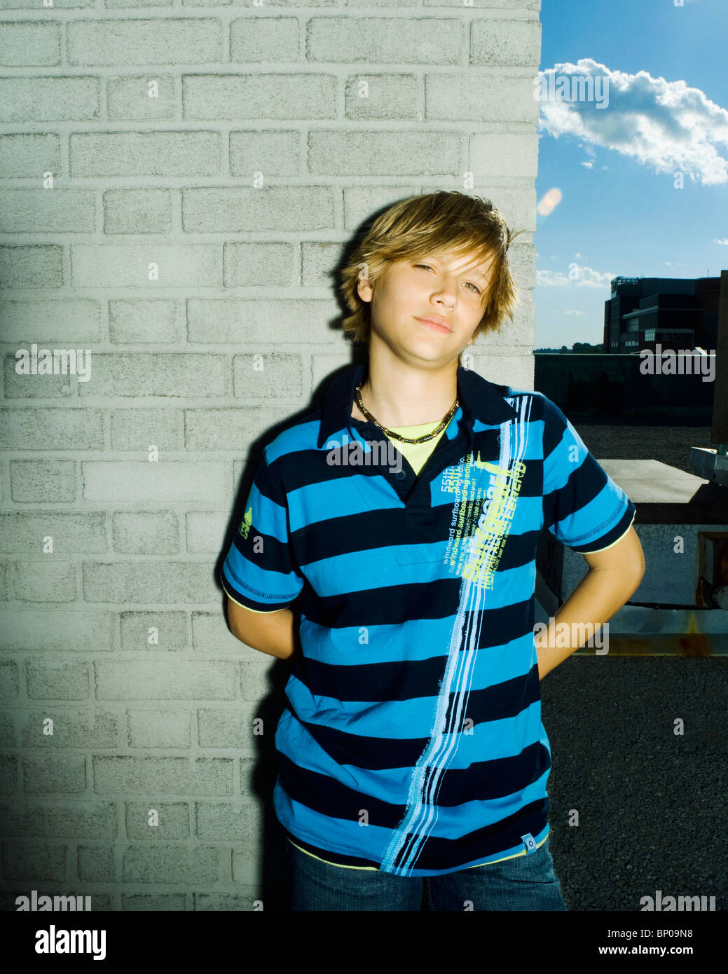 Teenage boy on building roof Stock Photo - Alamy