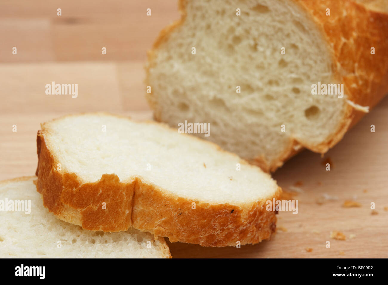 close up of small french baton bread sliced on a wooden block Stock ...
