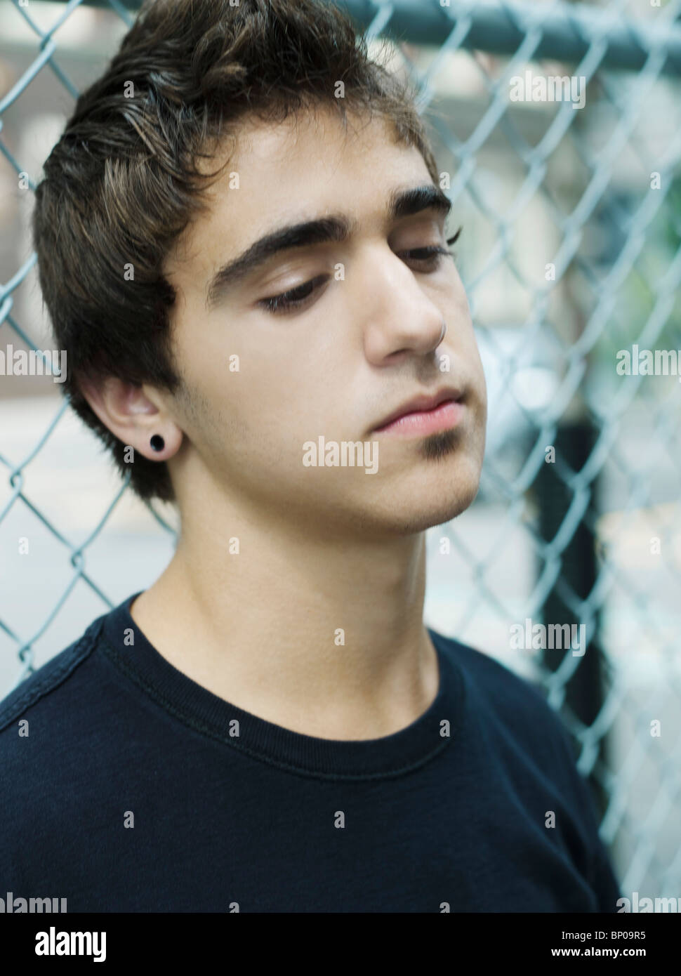 Portrait of sad-looking teenage boy Stock Photo - Alamy