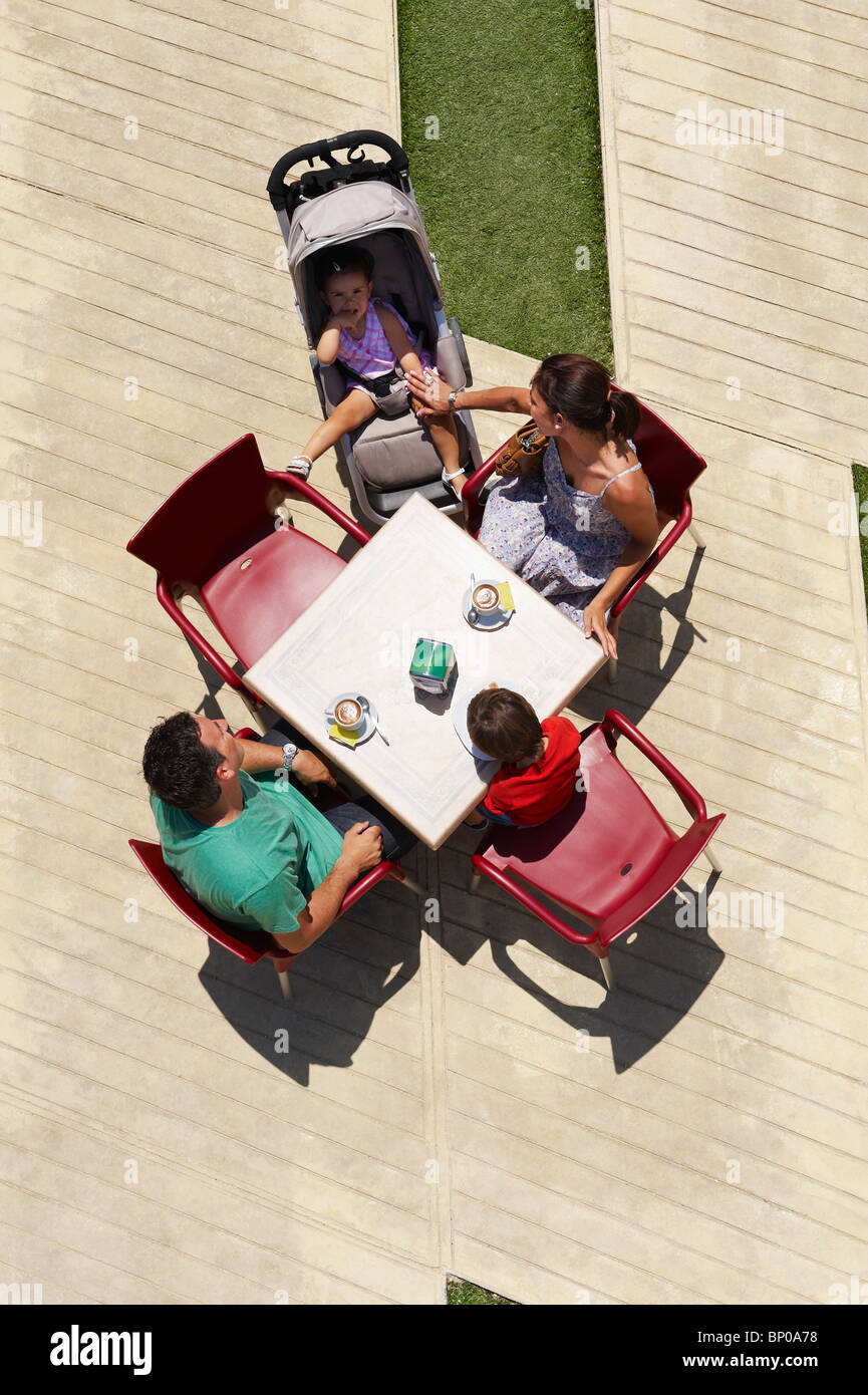 Family seated around table Stock Photo - Alamy