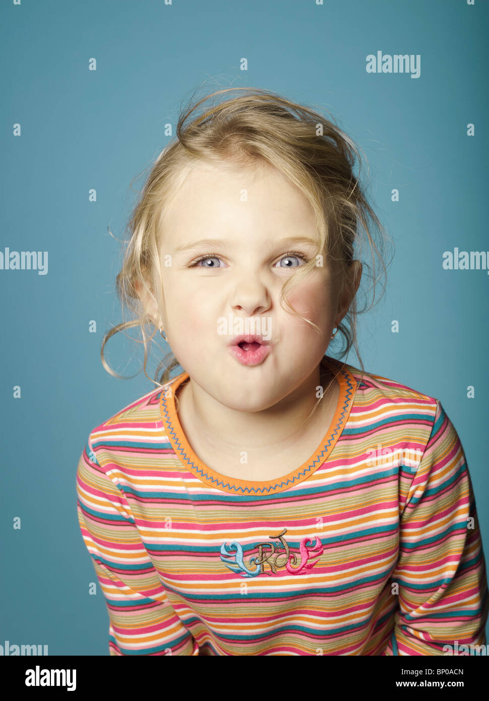 Portrait of little girl making a face Stock Photo - Alamy
