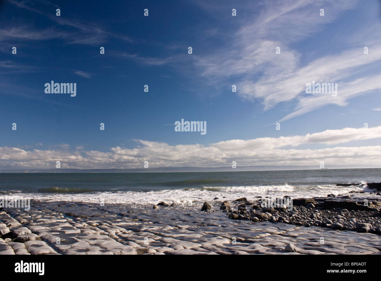 Limestone coastal pavement with breakers and cloud detail Stock Photo ...