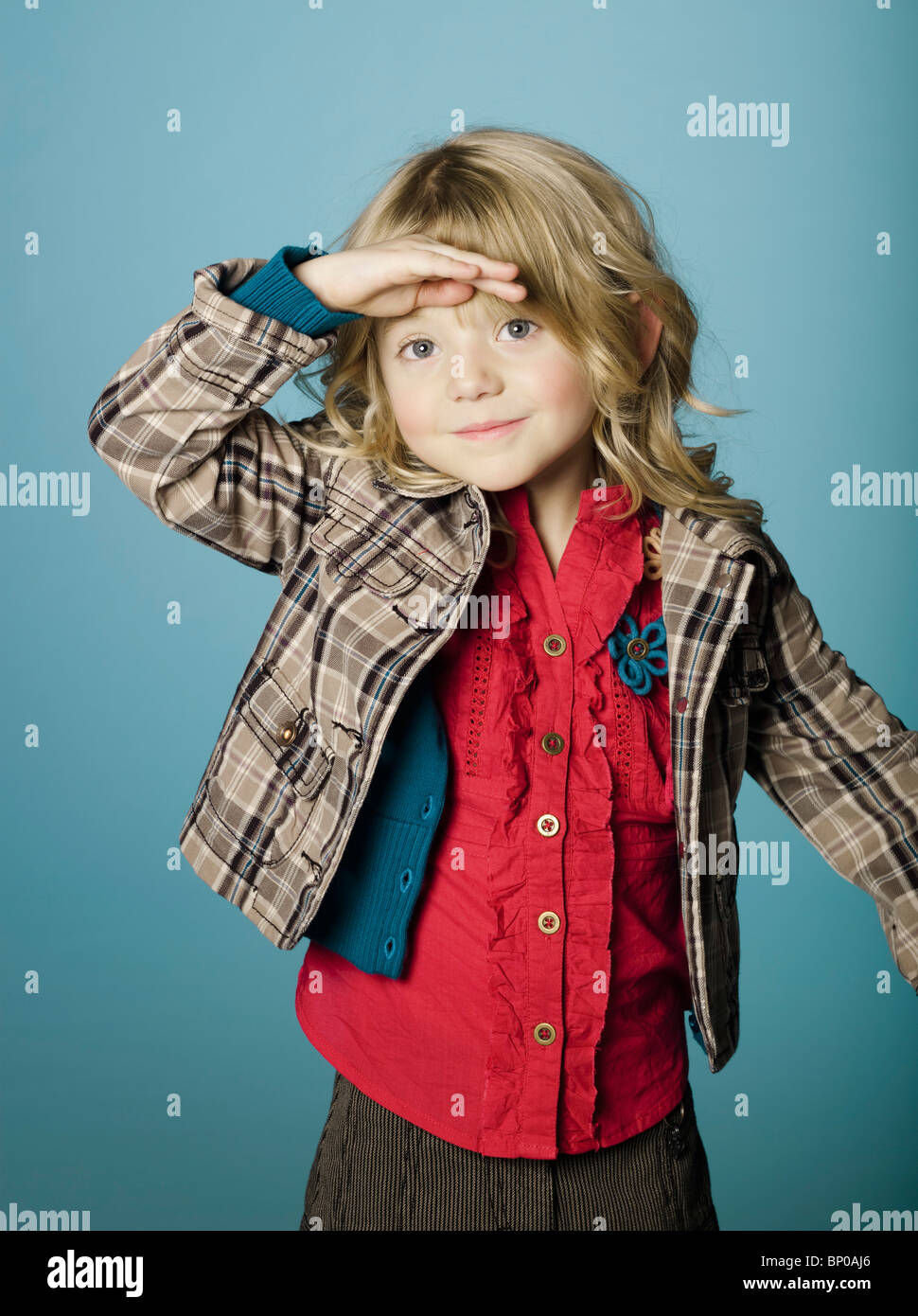 Little girl shielding eyes Stock Photo - Alamy