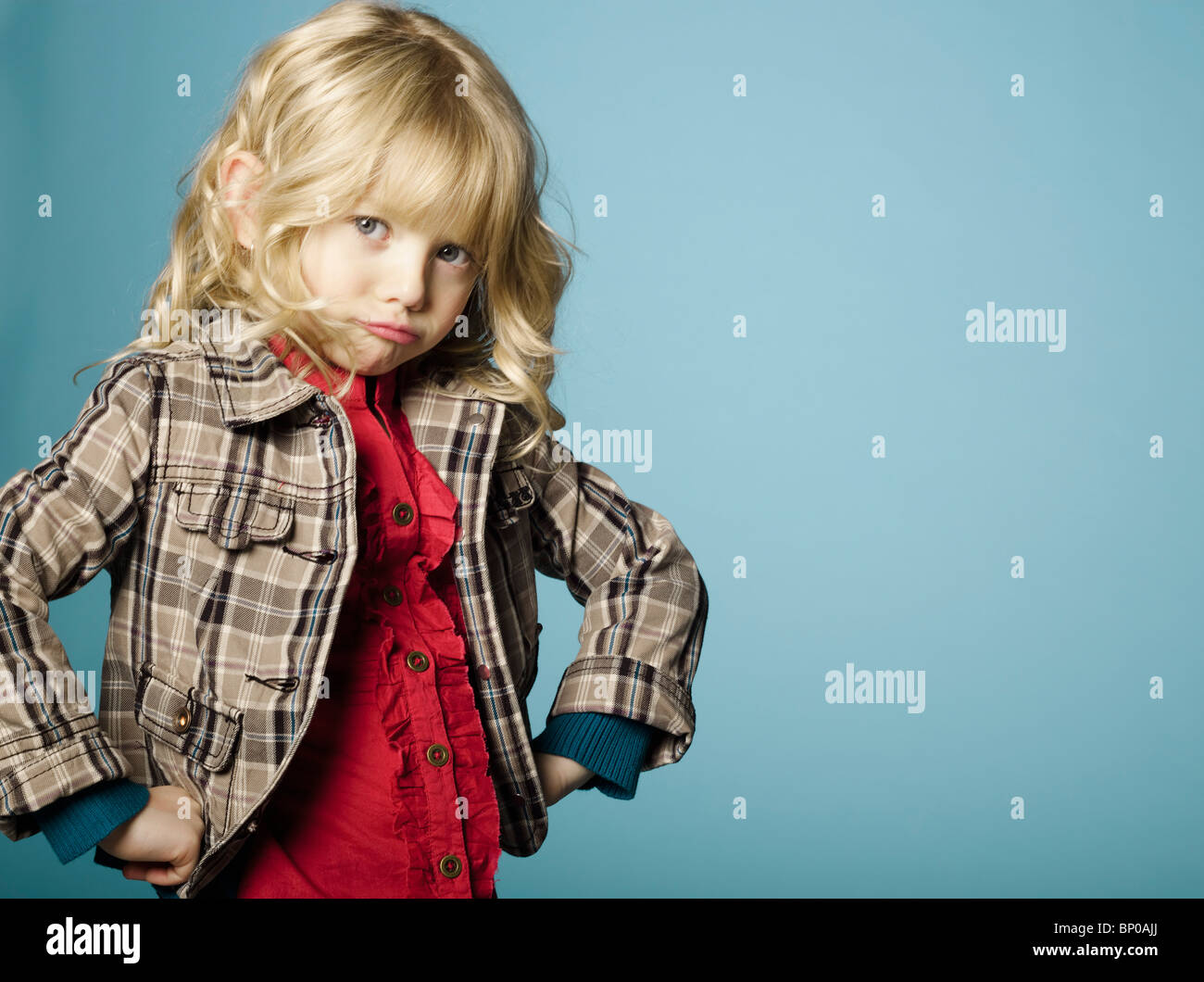 Little girl looking angry, arms akimbo Stock Photo - Alamy