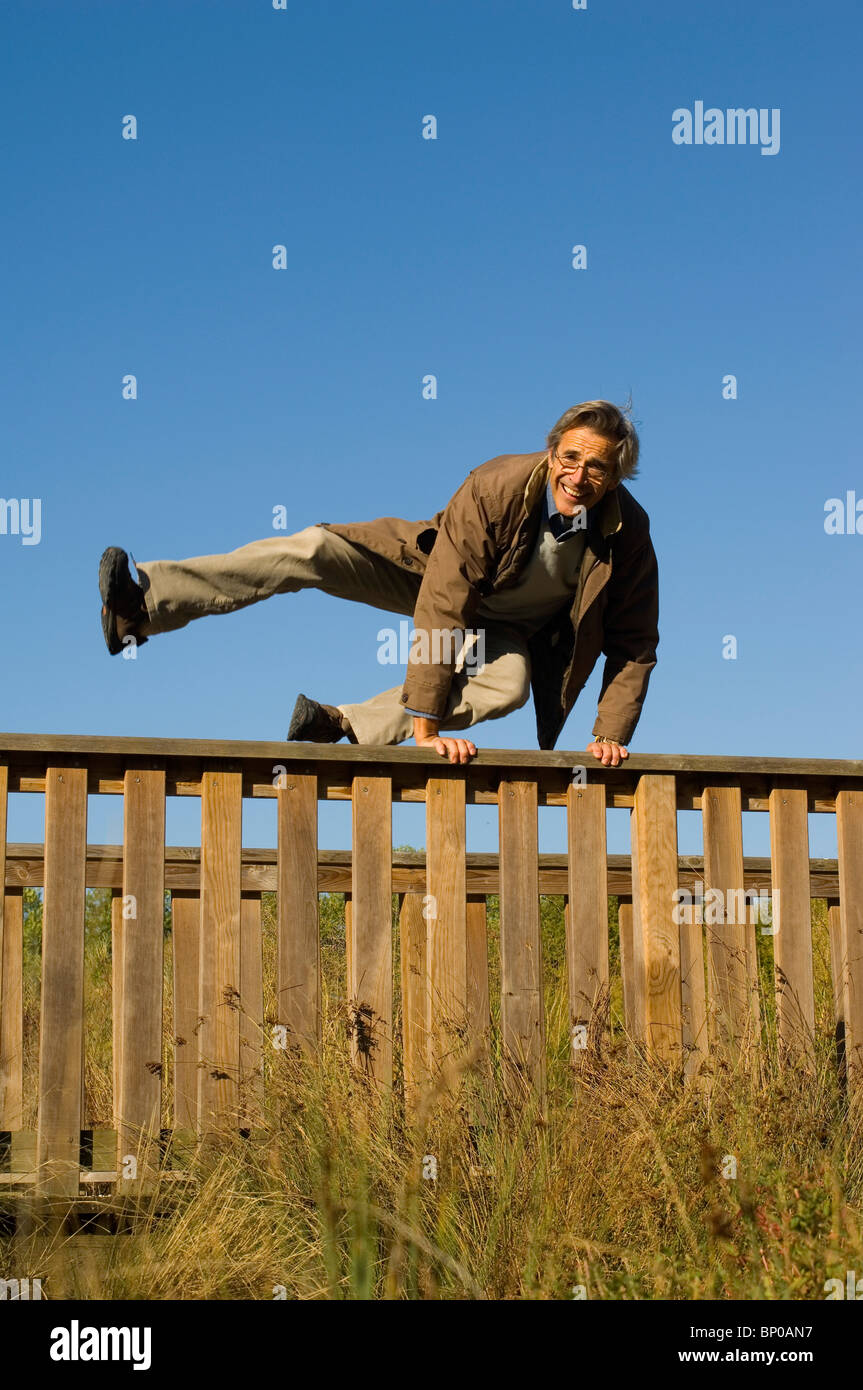 Man jumping over fence Stock Photo - Alamy Man jumping over fence Stock Photo - Alamy