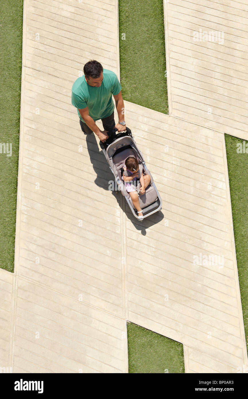 Father pushing push-chair Stock Photo - Alamy
