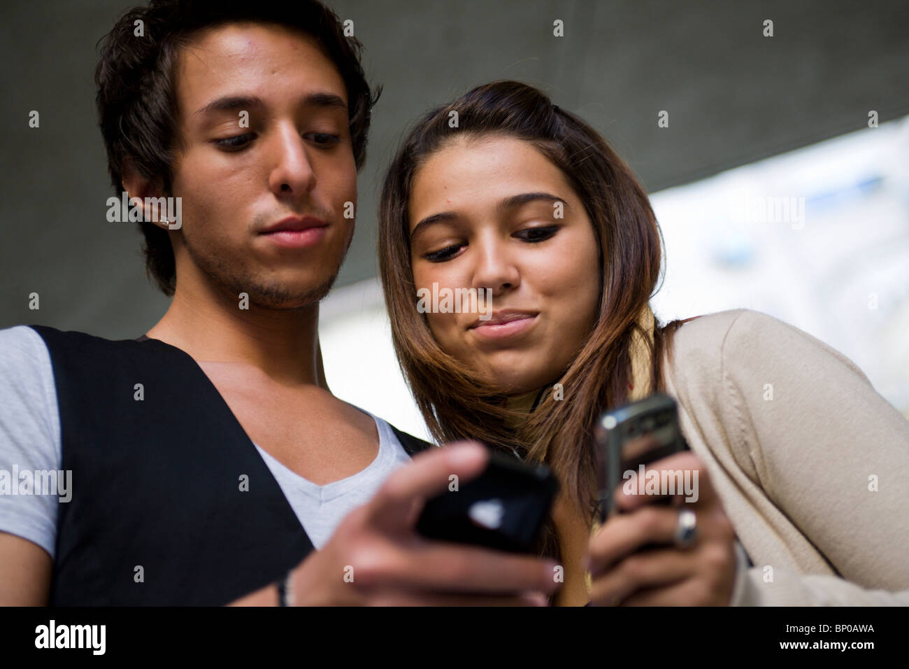 Teenagers using mobile phones Stock Photo - Alamy