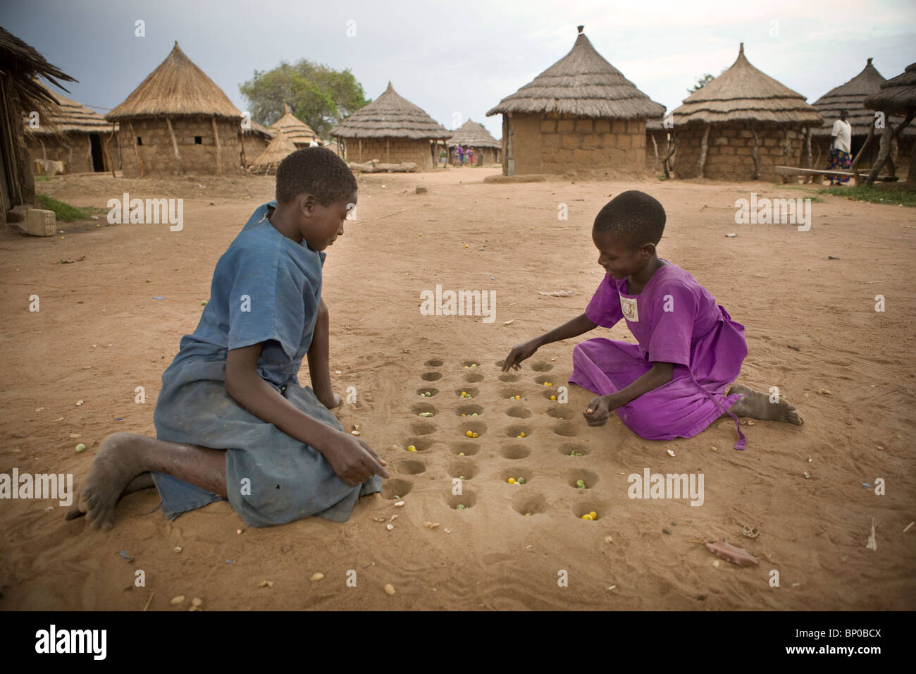 Girls play the board game mankala (or mancala) in Acowa refugee camp ...