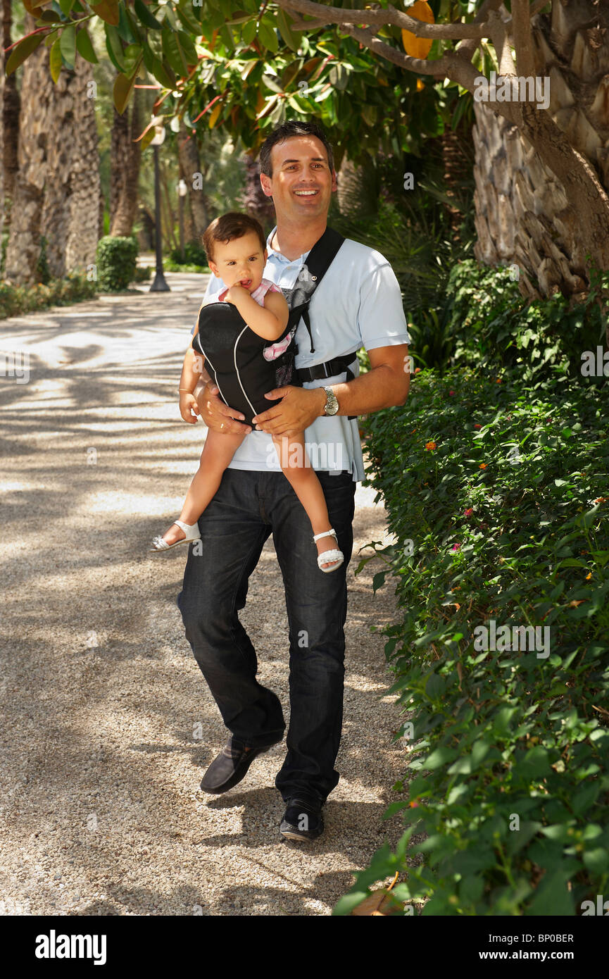 Father carrying baby in park Stock Photo - Alamy