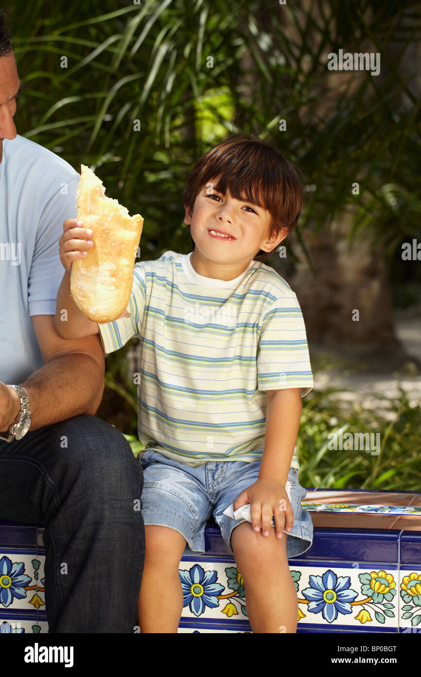 Boy holding piece of bread Stock Photo - Alamy