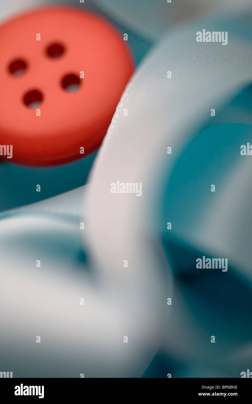 Red button with blue ribbon Stock Photo - Alamy