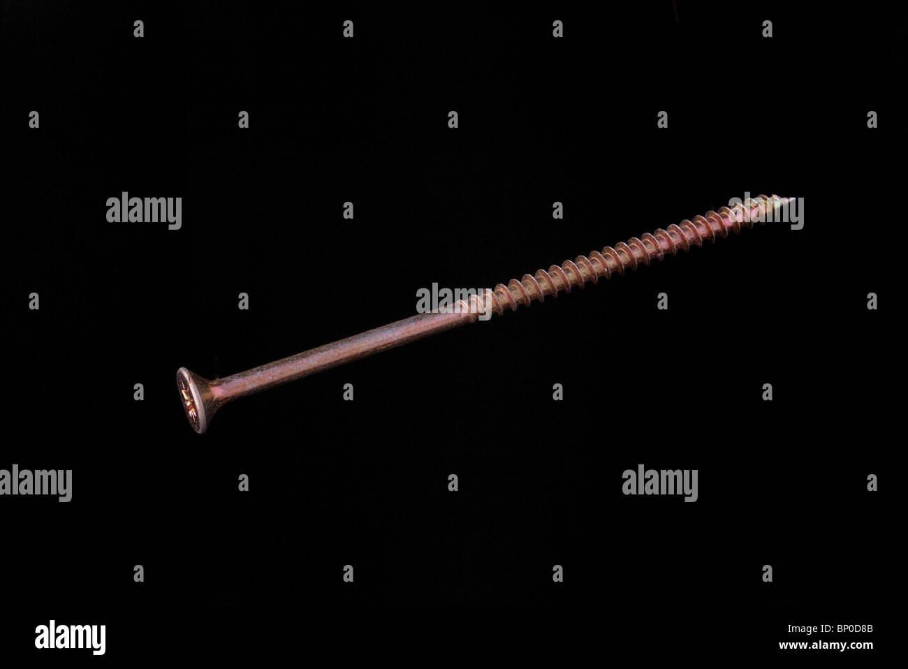 Brass wood screw on a black background Stock Photo - Alamy