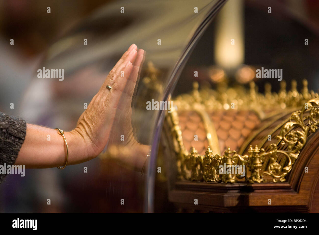 A Worshipers places her hand on the relics of Saint Therese of Lisieux ...