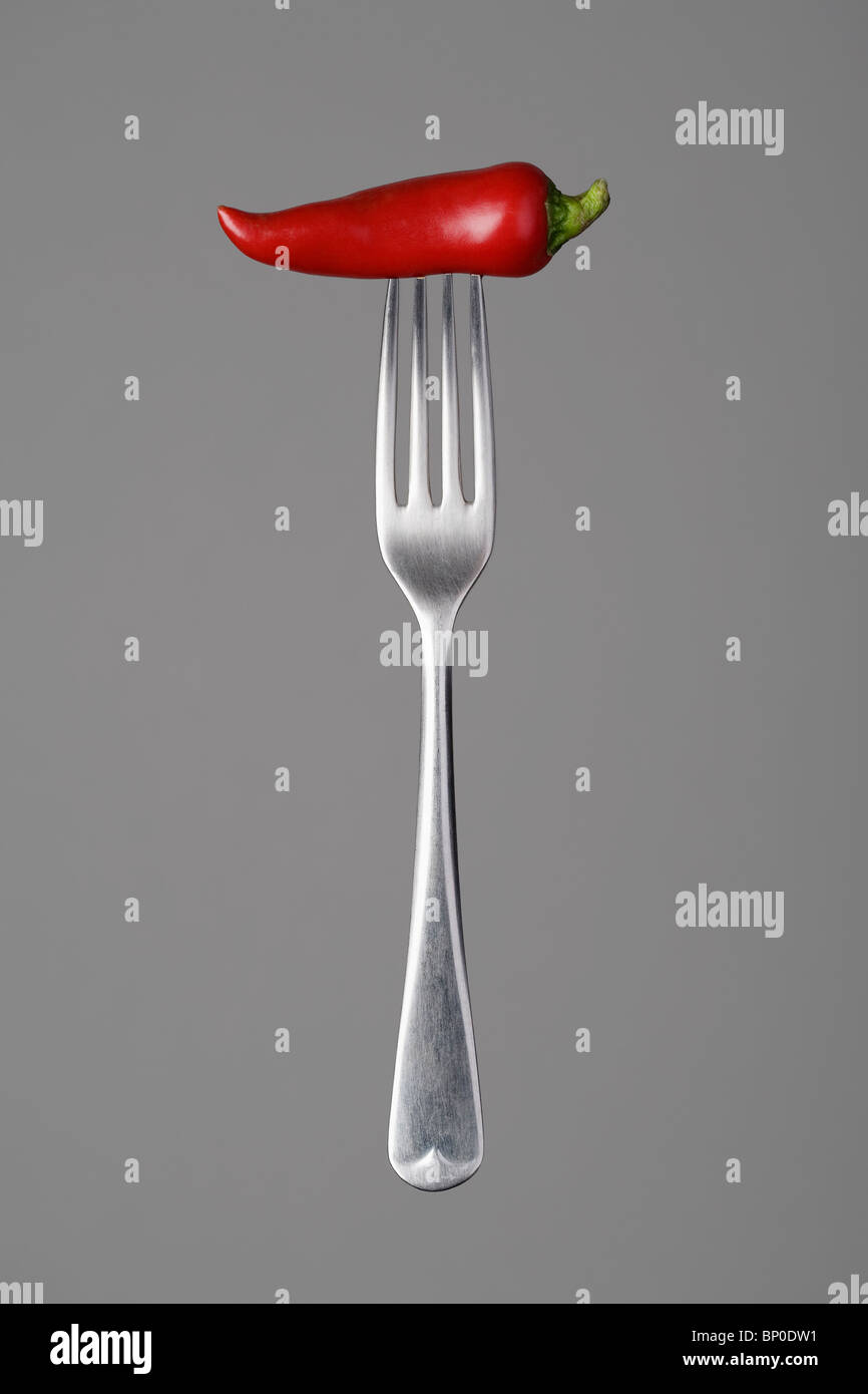 Fork with a chili pepper Stock Photo - Alamy