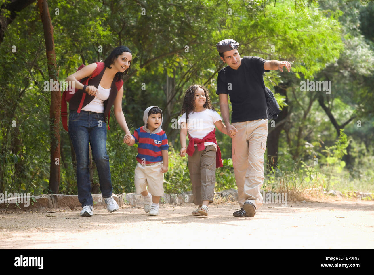 Family going for a walk in a park Stock Photo - Alamy