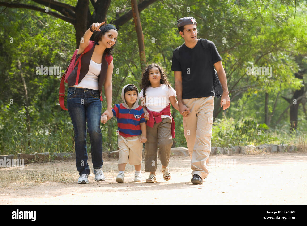 Family going for a walk in a park Stock Photo - Alamy