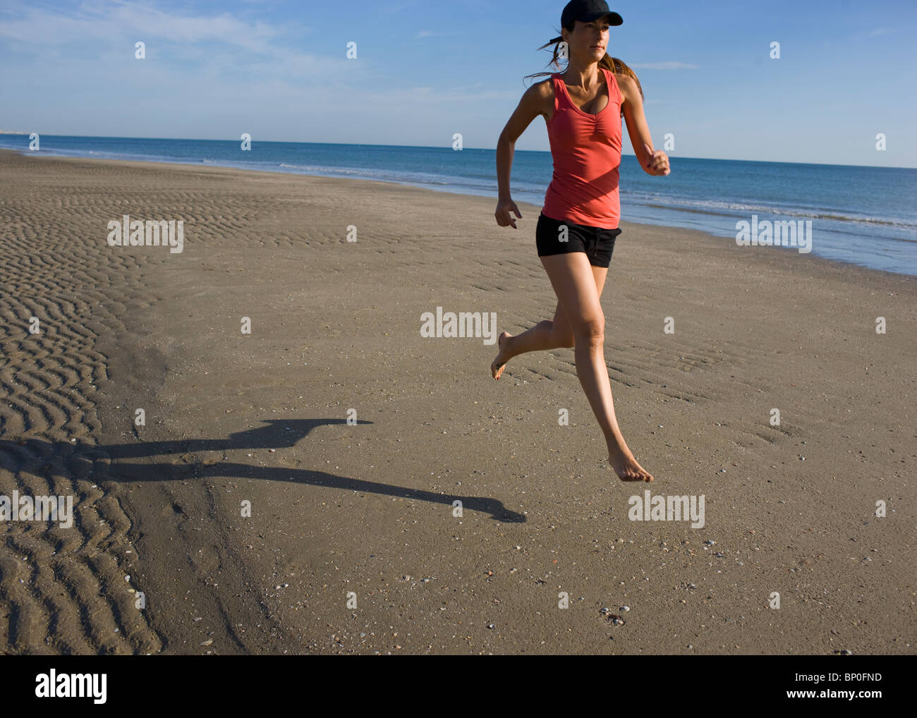 Woman jogging on the beach Stock Photo - Alamy