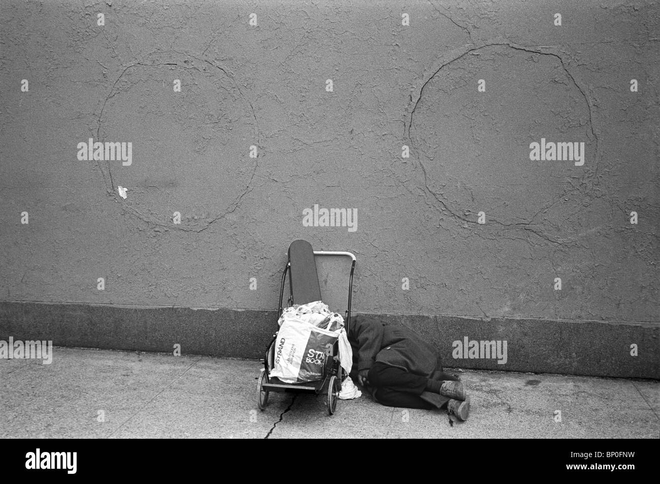 Homeless man sleeping street sidewalk Black and White Stock Photos ...