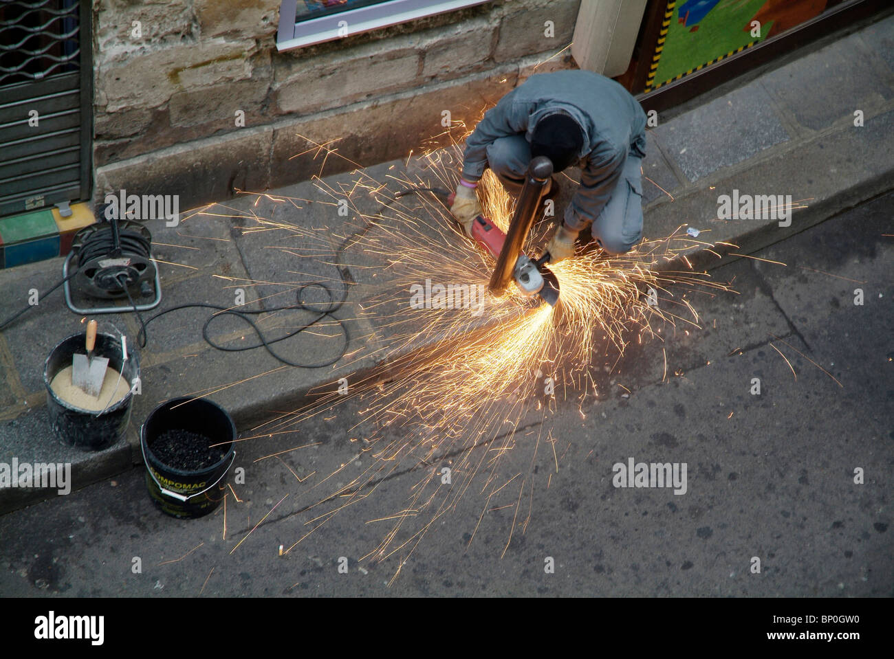 Man using dry-cutting saw in the street Stock Photo - Alamy