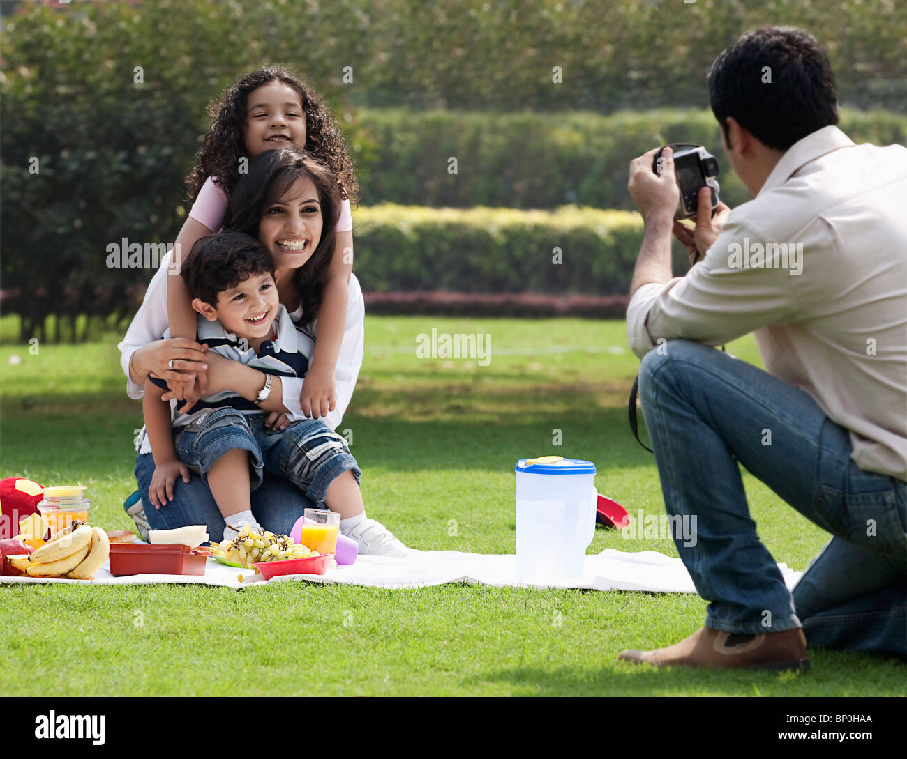 Man taking a photograph of his family Stock Photo - Alamy