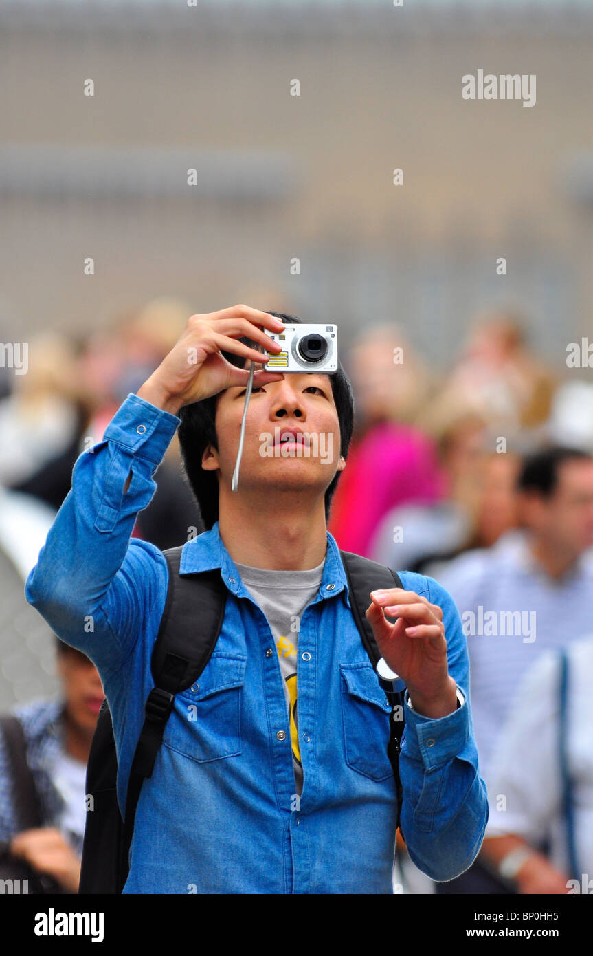 Tourist in London taking a picture with his digital compact camera ...