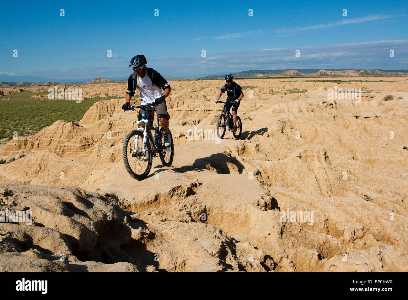 Spain, Navarre, two men on mountain bike in Bardenas Reales desert ...