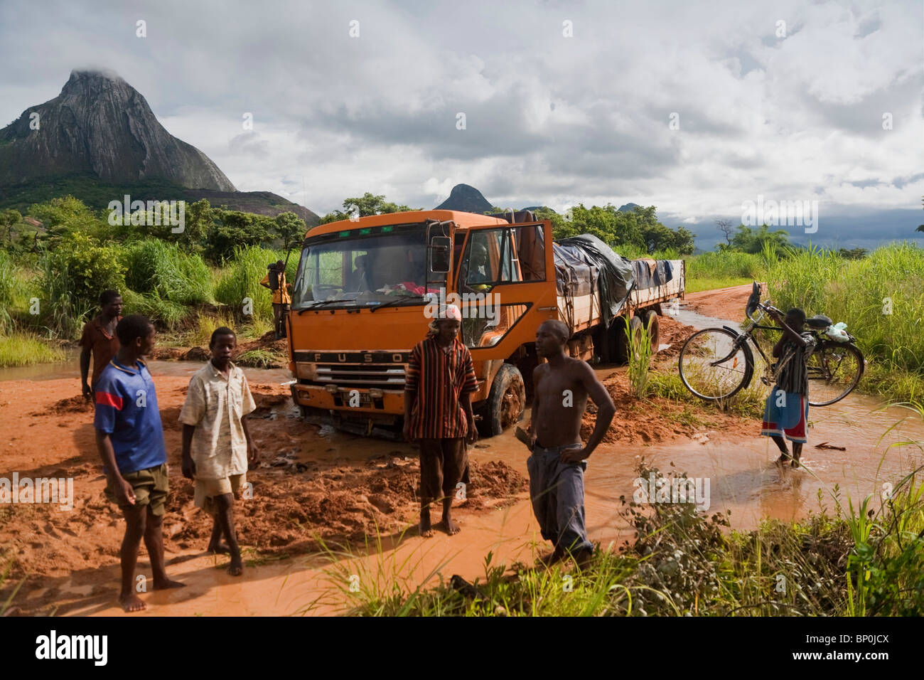 Mozambique, near Nampula. A man carries his bike through the floods ...