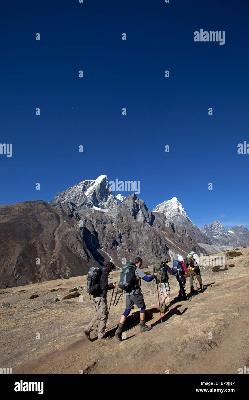 Nepal, Everest Region, Khumbu Valley. A group of trekkers make their ...