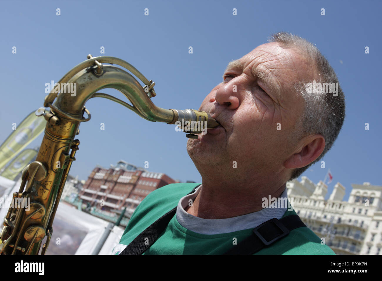 Saxophone player playing solo on Brighton Beach during June Bank ...