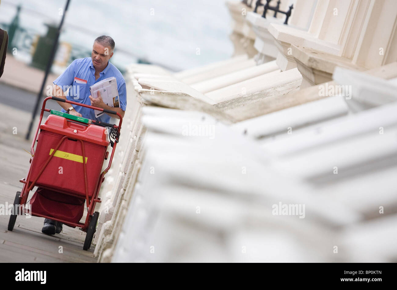A postman delivers mail in Hove, East Sussex. Picture by James Boardman ...