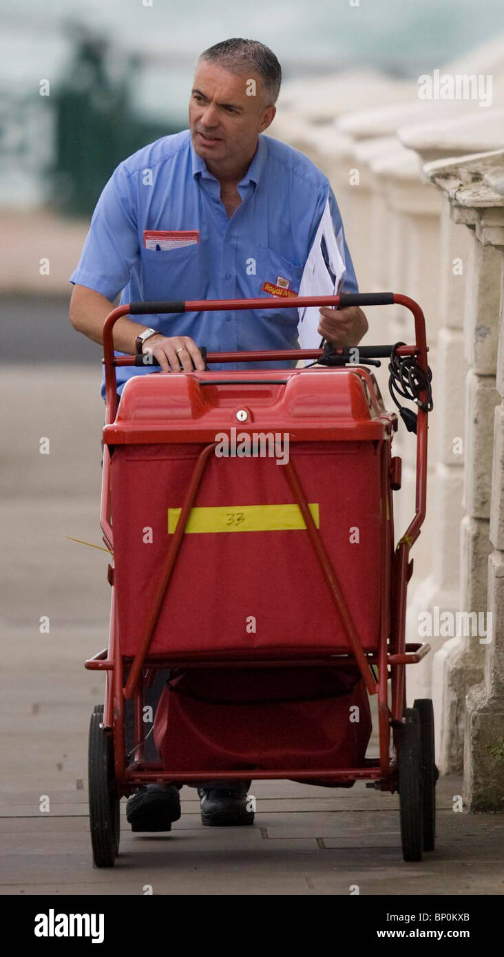 A postman delivers mail in Hove, East Sussex. Picture by James Boardman ...