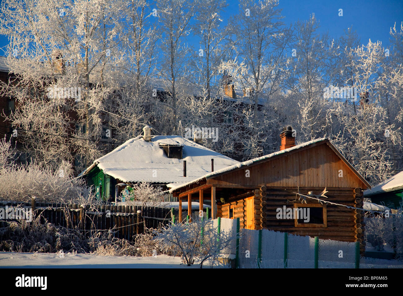 Russia; Siberia; Irkutsk; Wooden houses covered in snow surrounded by ...