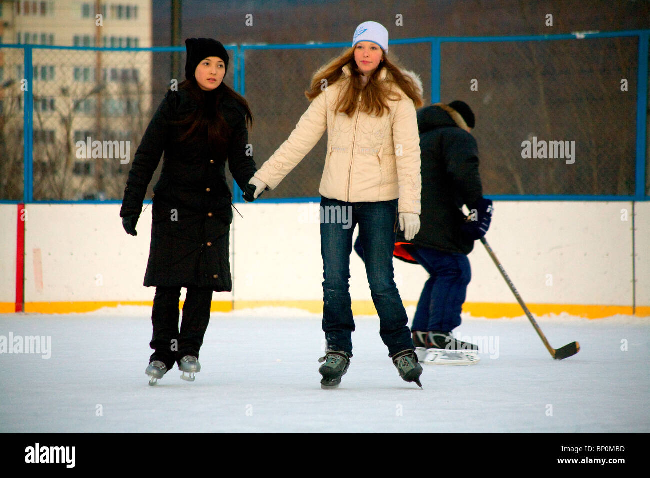 Russia, Far East, Sakhalin; Yuzhno-Sakhalinsk; Two young woman ice ...
