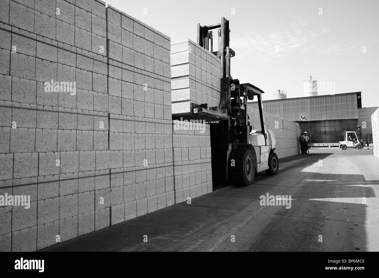 fork lift truck lifting cement blocks Stock Photo - Alamy