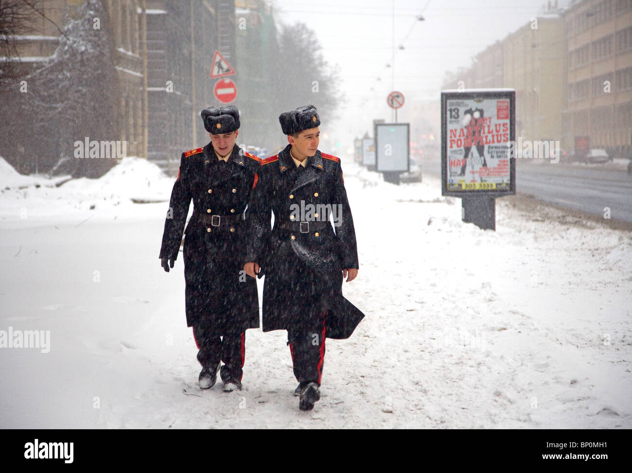 Russia, St. Petersburg; Two student soldiers walking in a snow storm ...