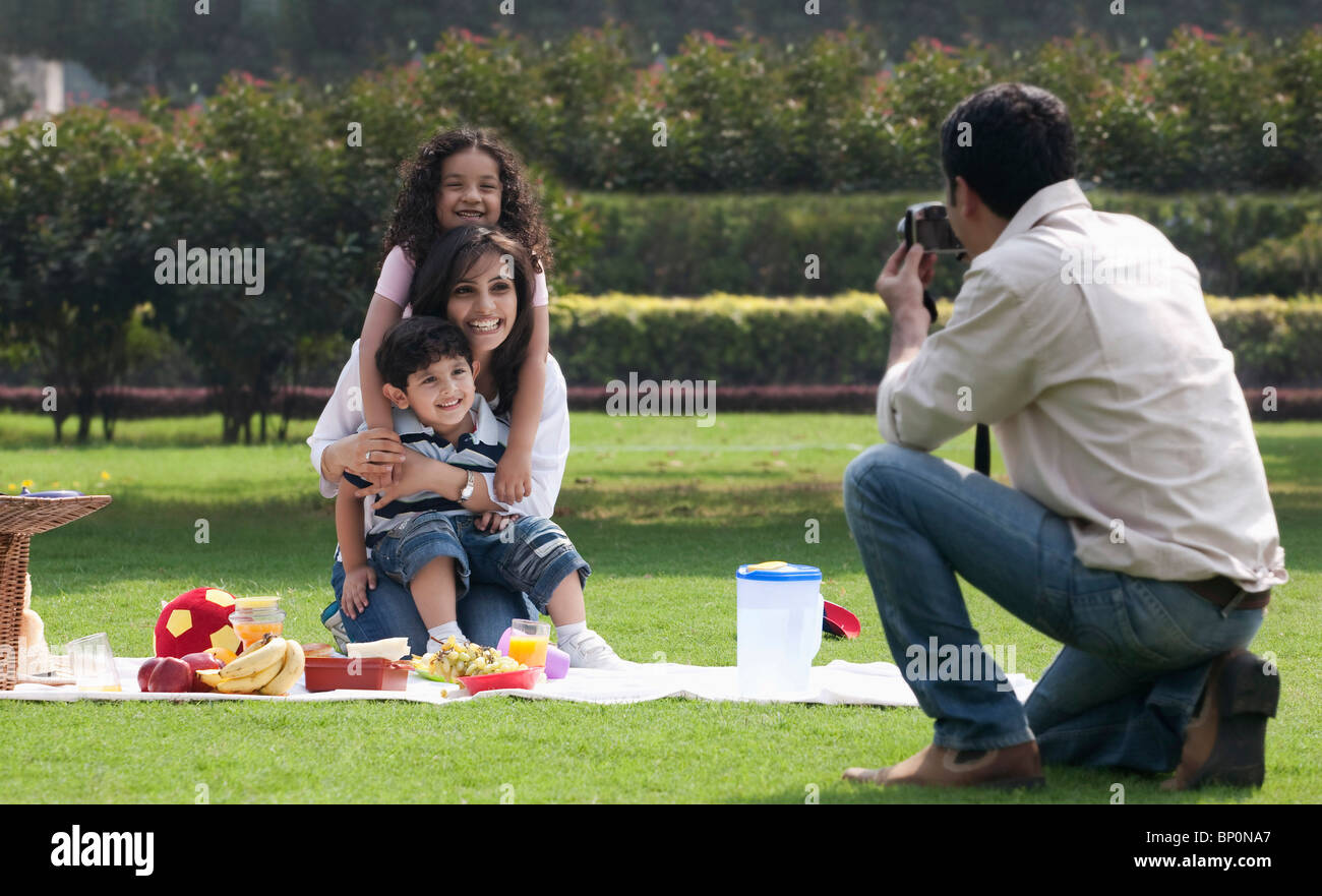 Man taking a photograph of his family Stock Photo - Alamy