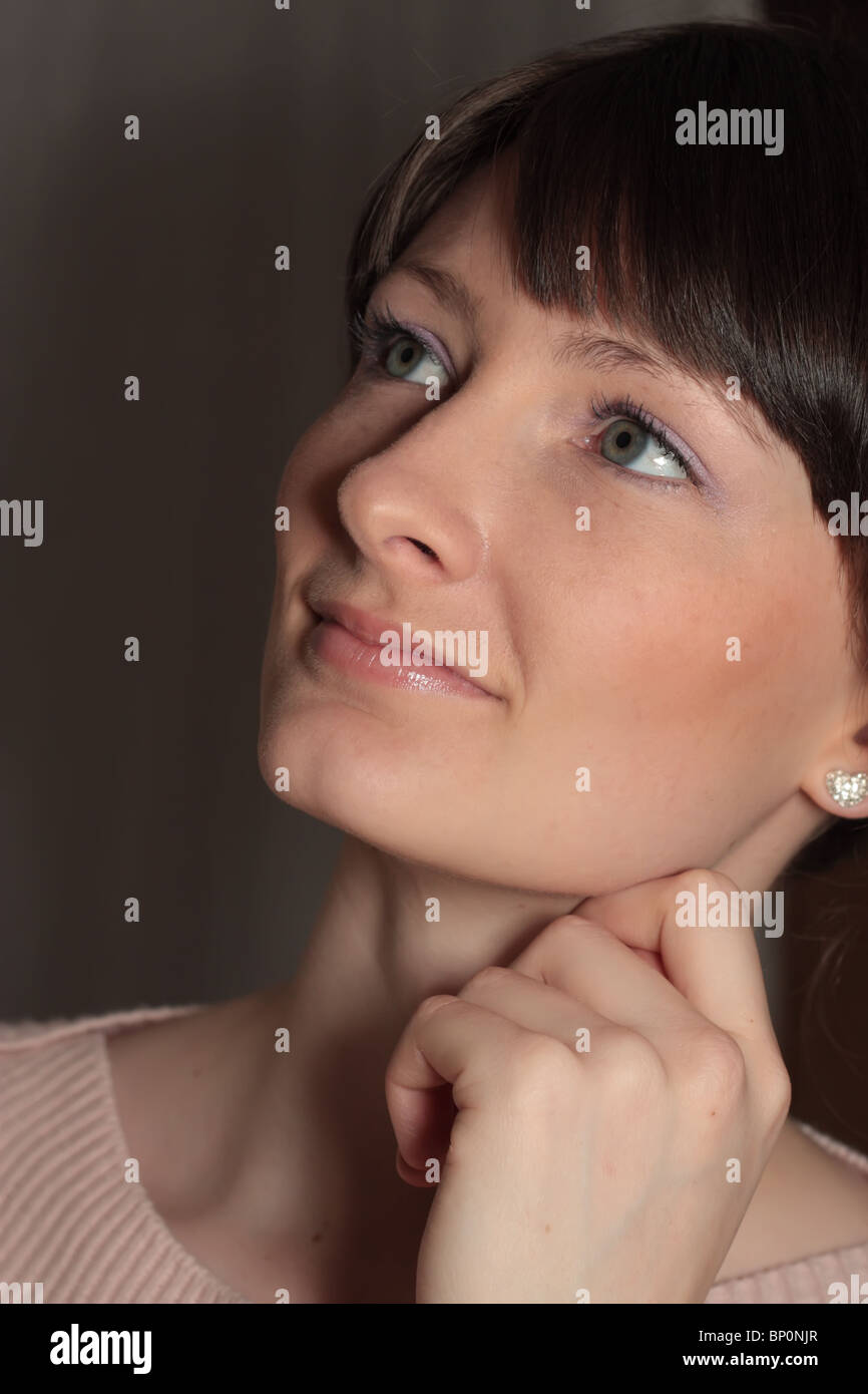 Girl Wondering Look with Hand on Face Stock Photo - Alamy