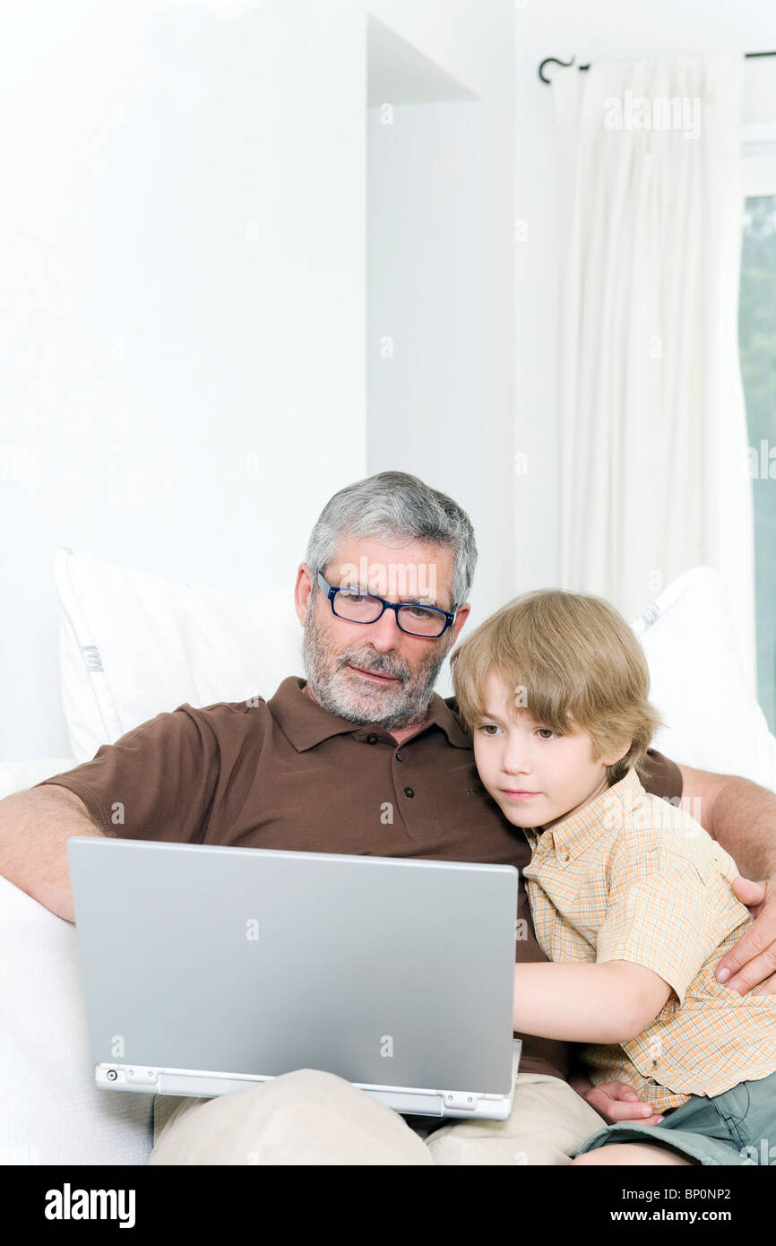 Man and child using laptop Stock Photo - Alamy