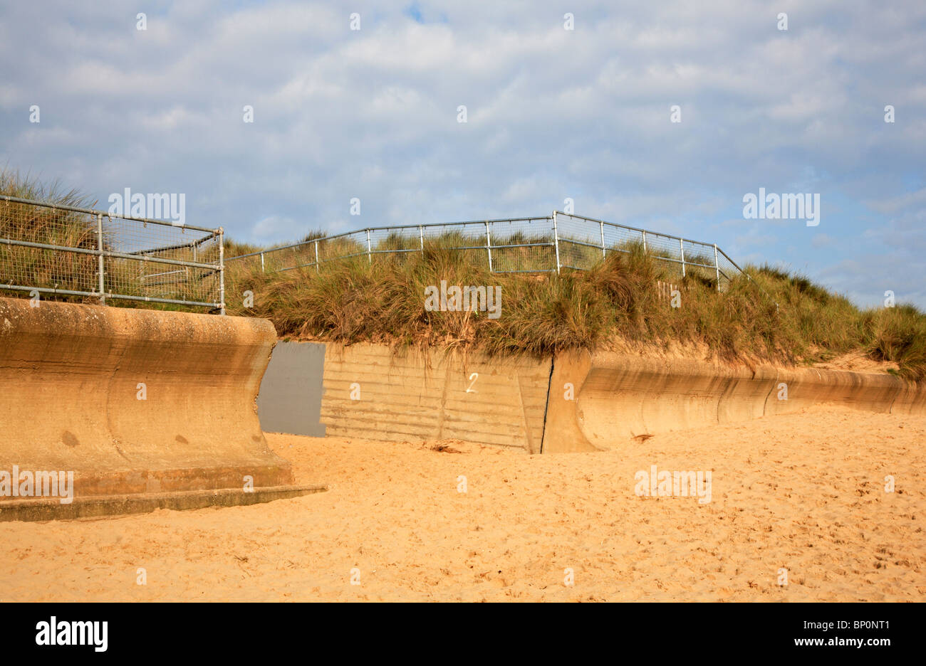 Sea wall and access through sand dunes to the beach at Waxham, Norfolk ...