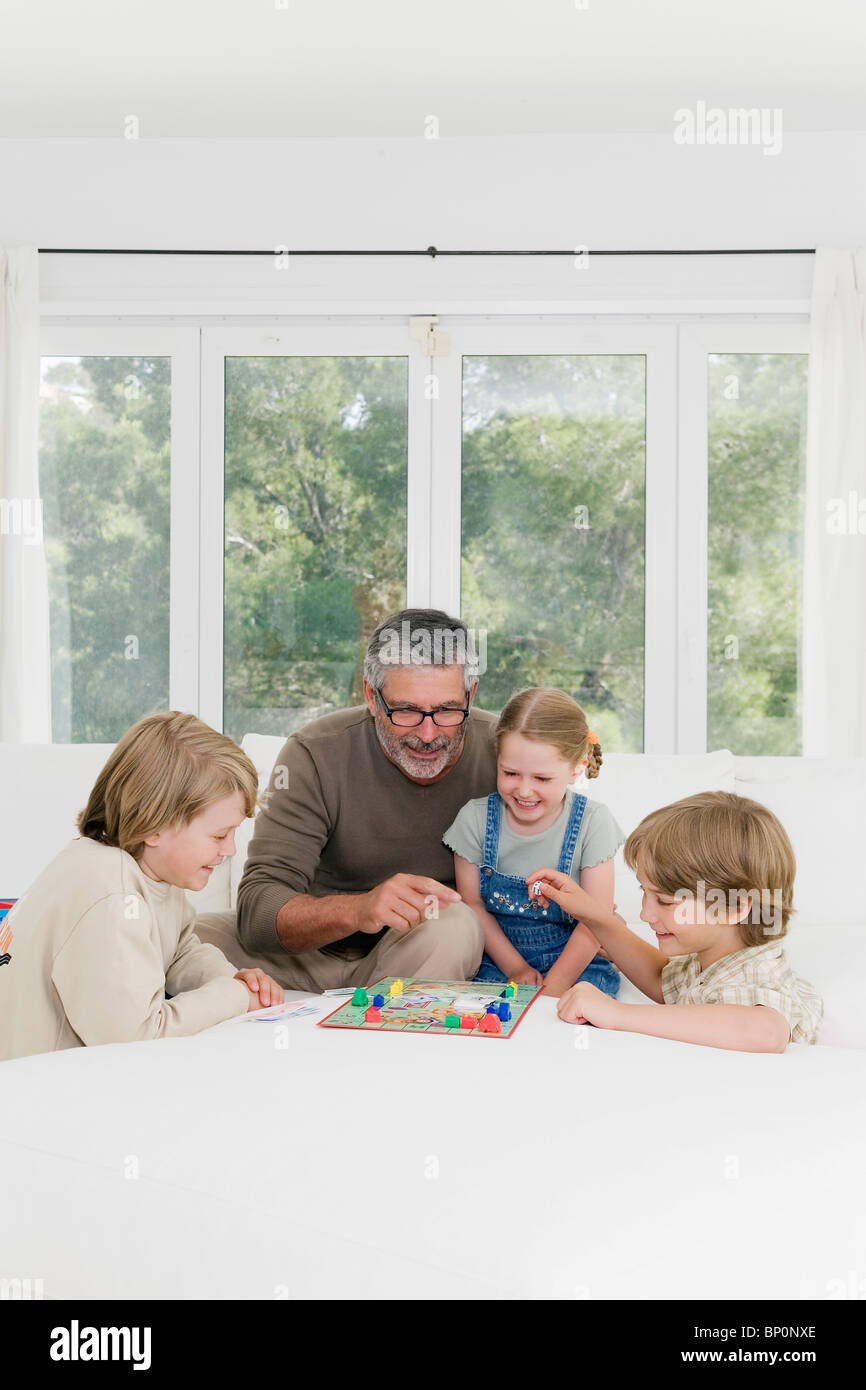 Family playing monopoly Stock Photo - Alamy