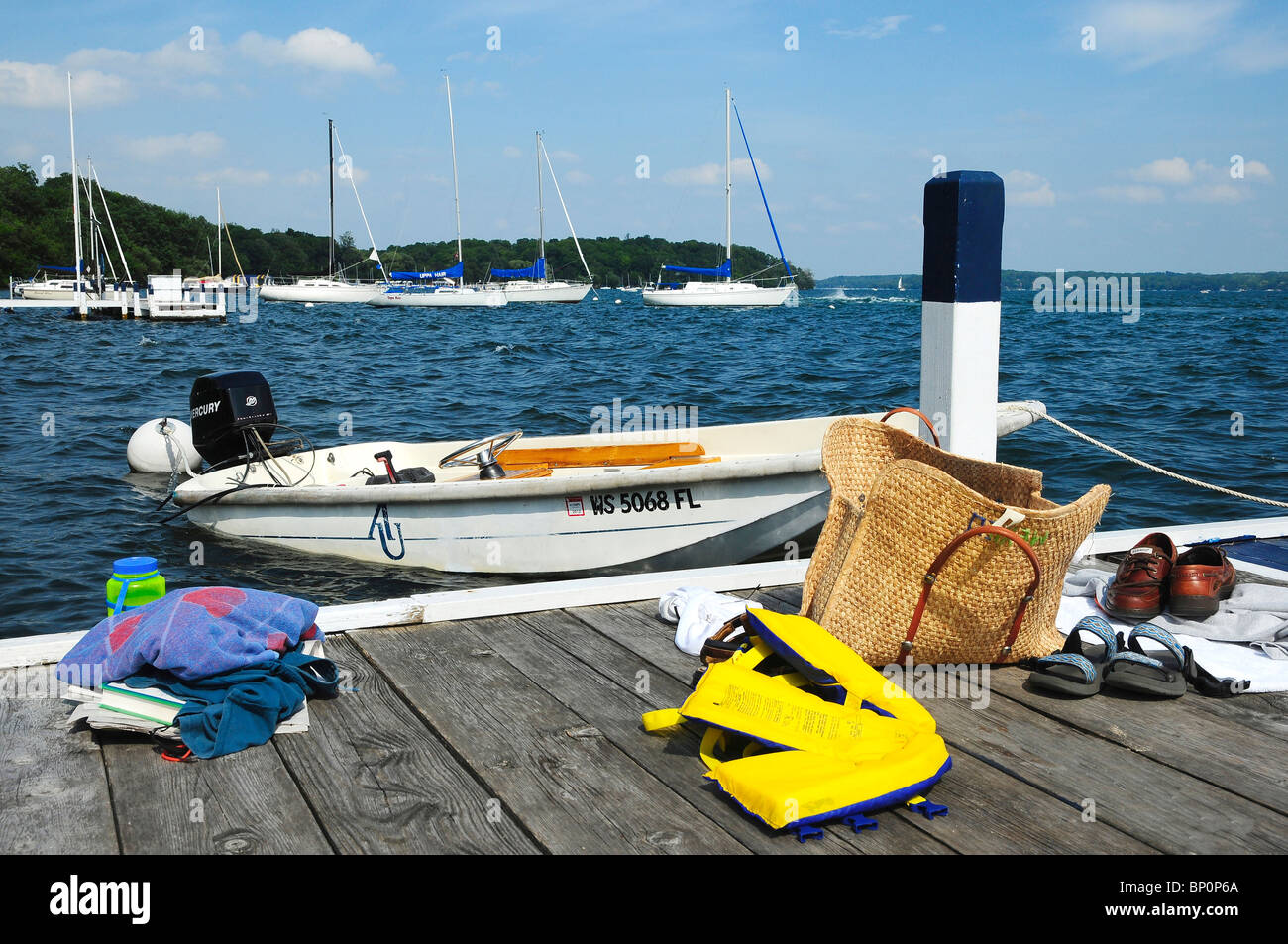 Pier still life with items left while swimming Stock Photo - Alamy