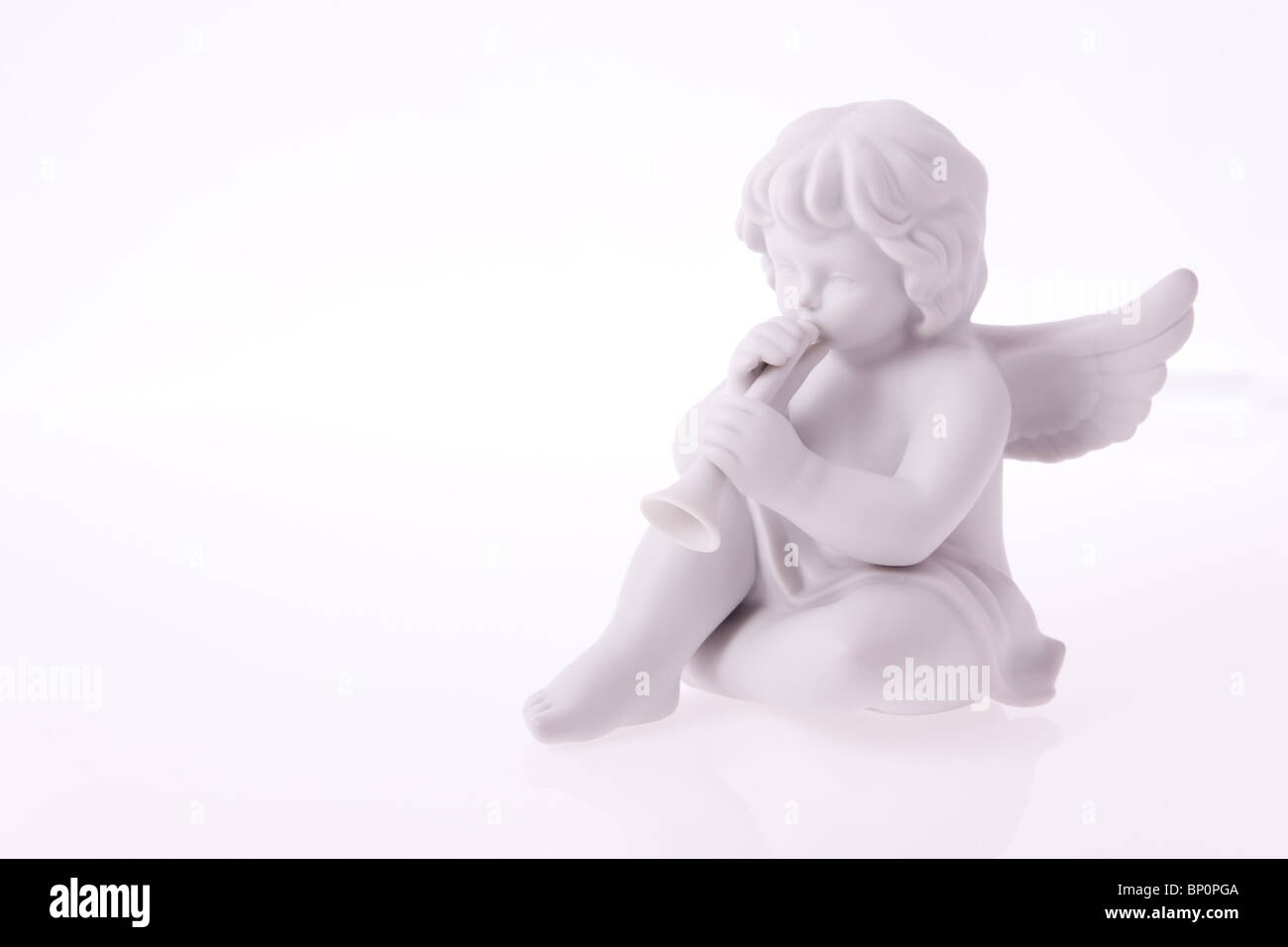 Macro photography of porcelain figurine of angel playing trumpet Stock ...