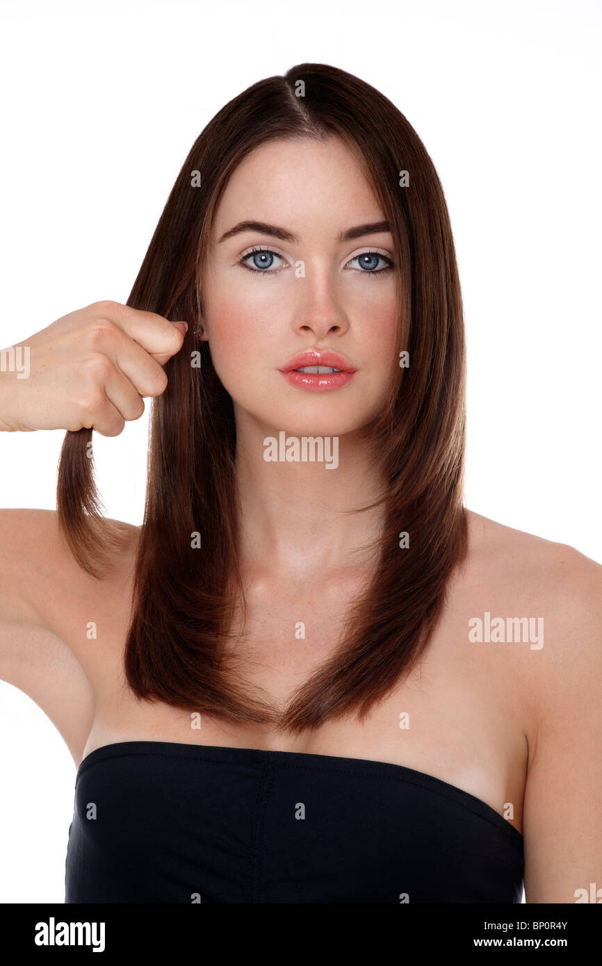 Young woman touching her hair Stock Photo - Alamy