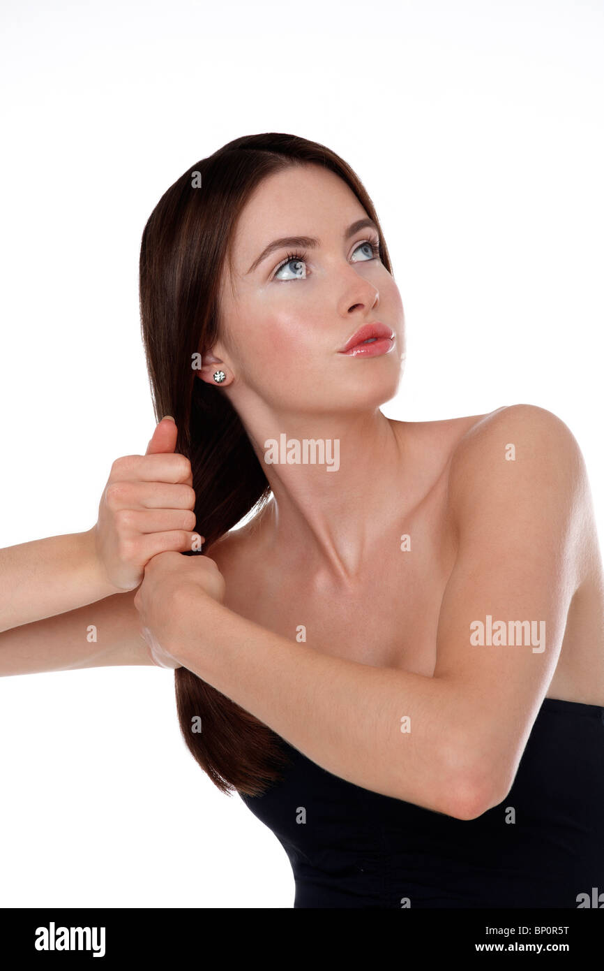 Young woman touching her hair Stock Photo - Alamy