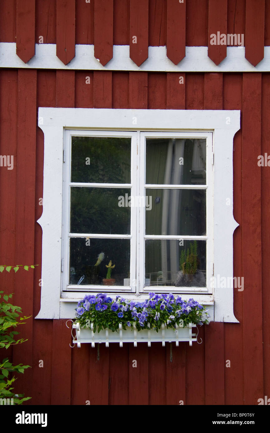 Window with flowers of a red Swedish country cottage Stock Photo - Alamy
